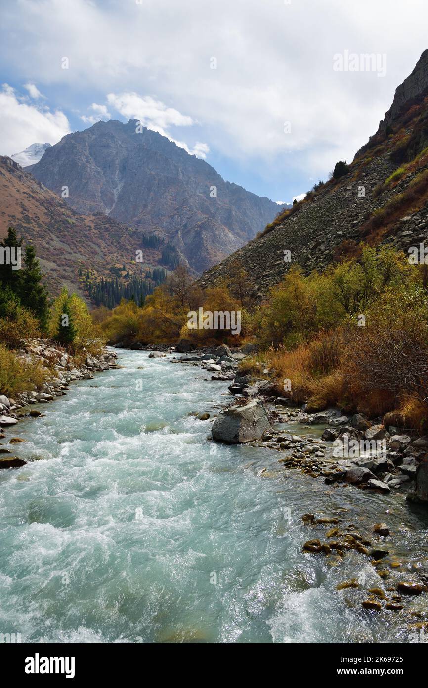 Ak Sai valley autumn landscape. Mountain river and view on high peaks ...