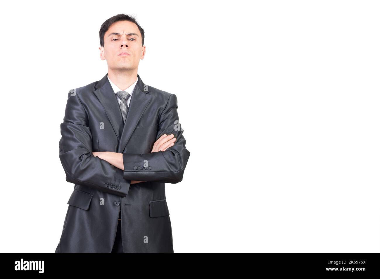 Strict young businessman in suit with crossed arms Stock Photo - Alamy