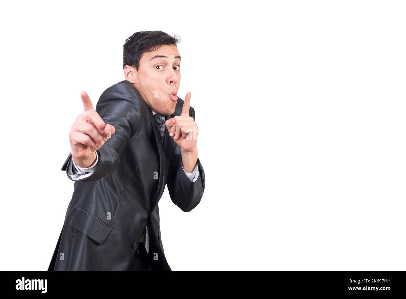 Man in elegant suit pointing up and looking at camera with funny face ...