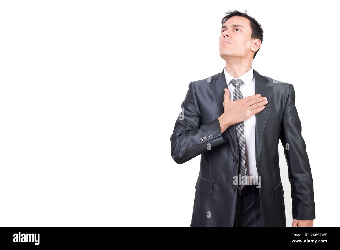 Serious man in suit keeping hand on heart showing honesty Stock Photo ...