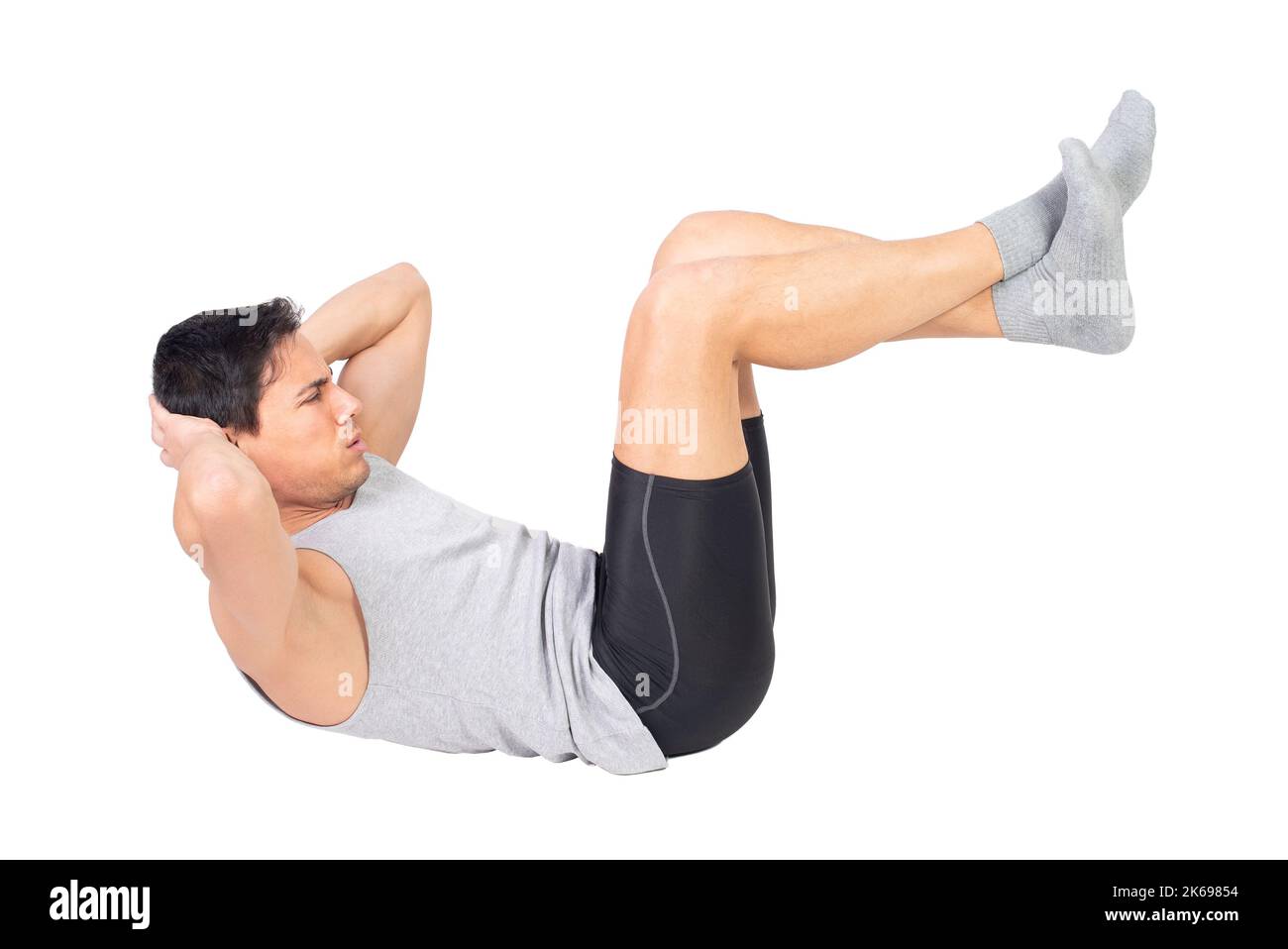 Strong sportsman in activewear performing abdominal crunches Stock ...