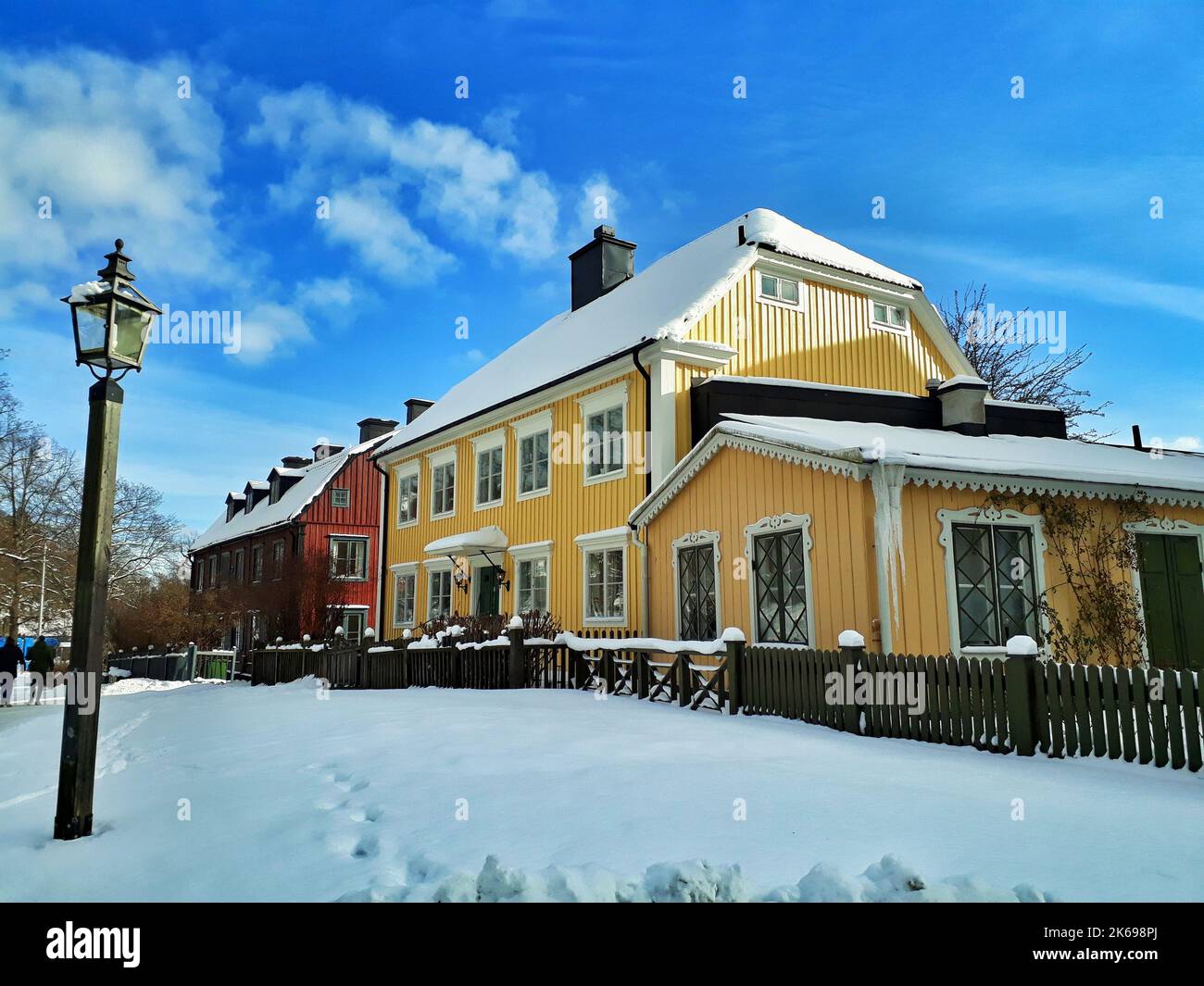A scenic view of beautiful houses covered by snow on a sunny day Stock ...