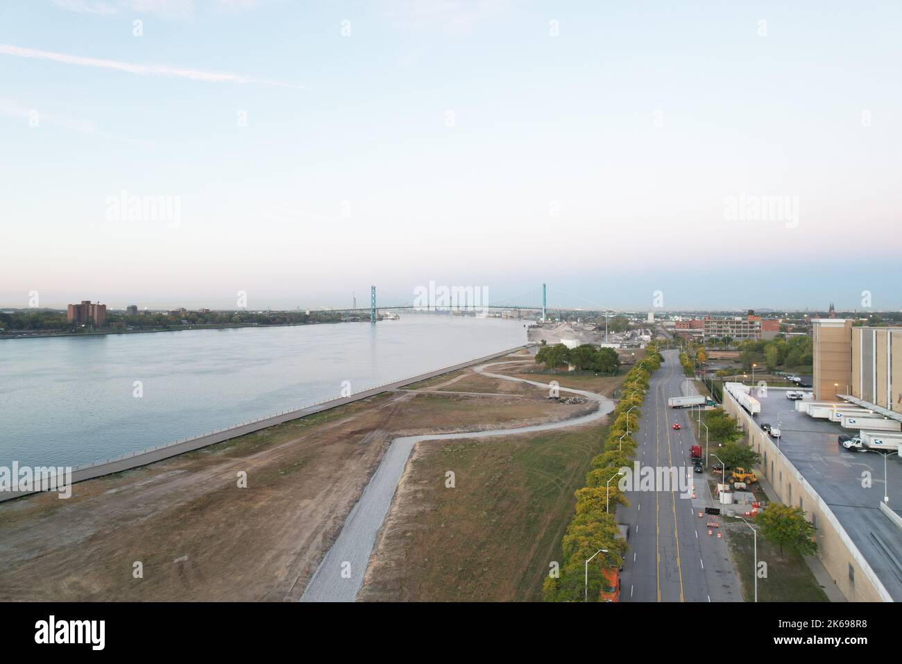 An aerial view of a highway next to a river stream in the city of ...