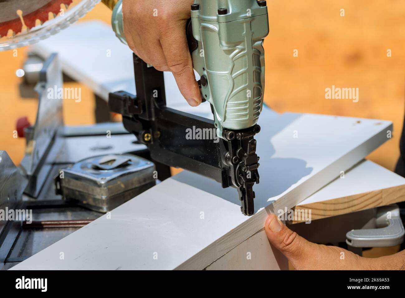Assembling wood boards with nails with pneumatic air gun is done by ...