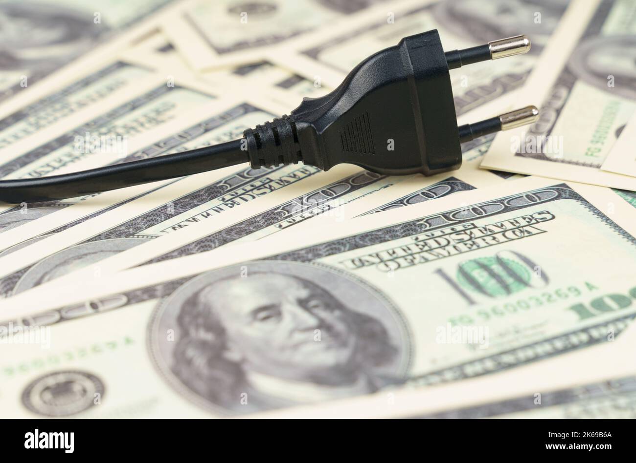 There is an electric plug on the dollar bills. The concept of the cost ...