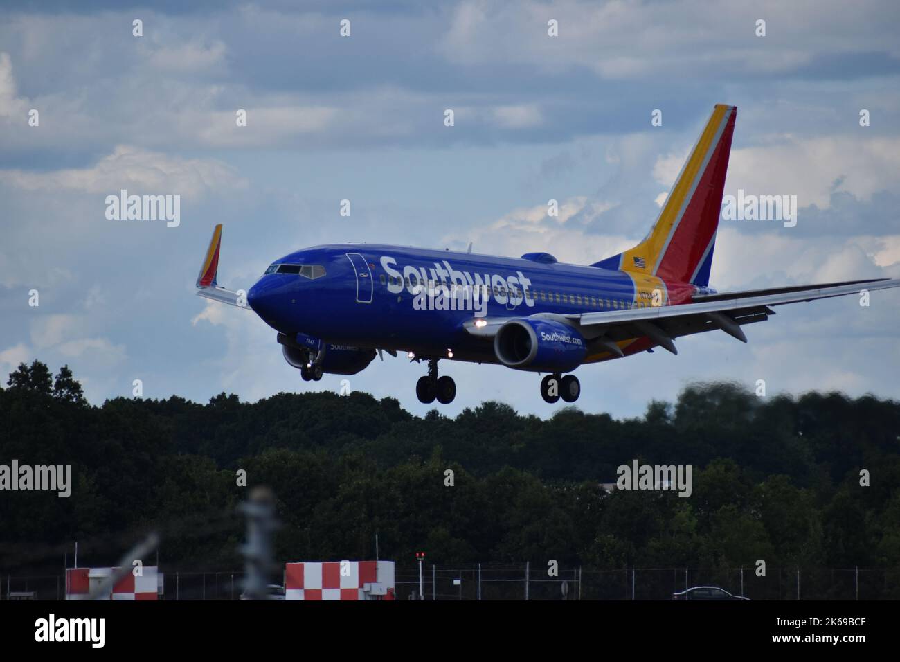 A blue plane with yellow and red empennage landing at T.F. Green ...