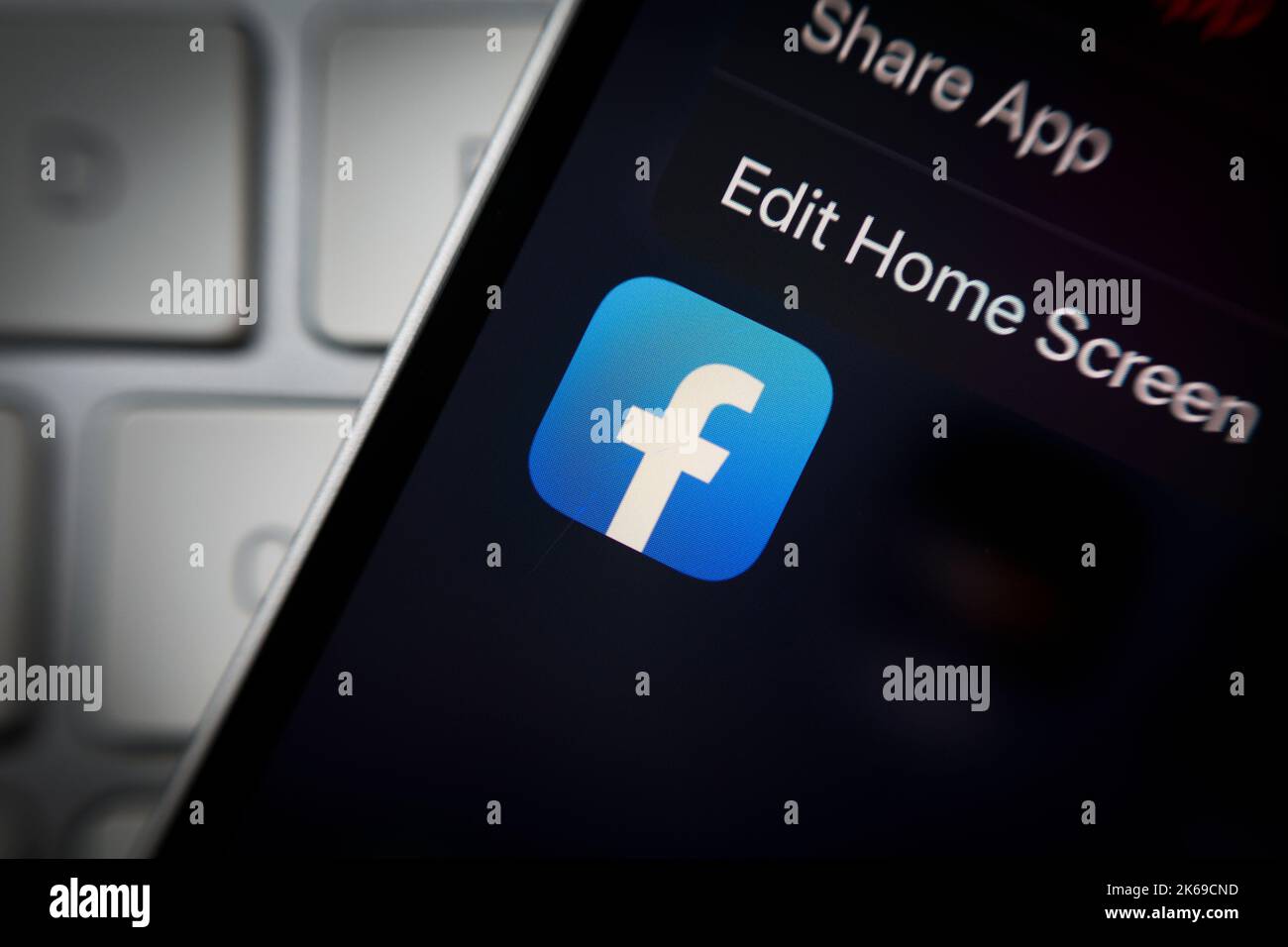 The Facebook logo is seen on an iPhone mobile device in this ...