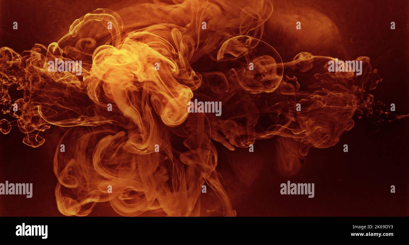 paint in water color smoke blast orange red glow Stock Photo - Alamy