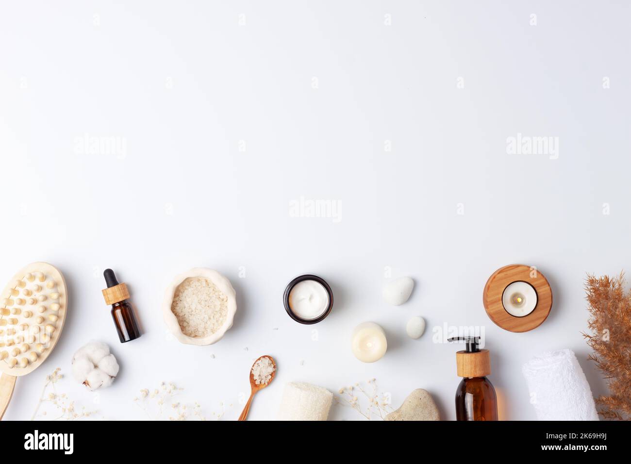 Spa treatment with natural skin care products flowers, towel and wash ...