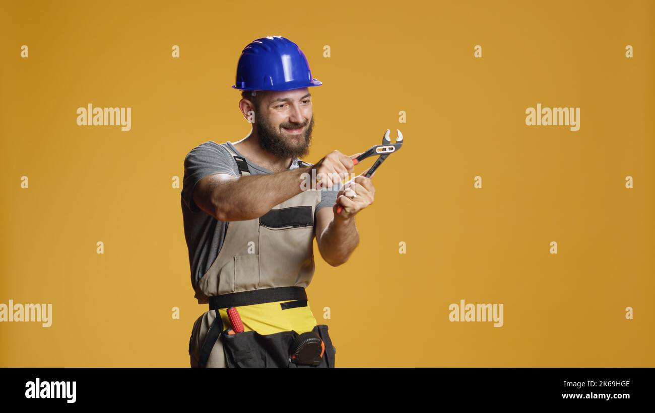 Construction craftsman working with steel wrench on renovation project ...