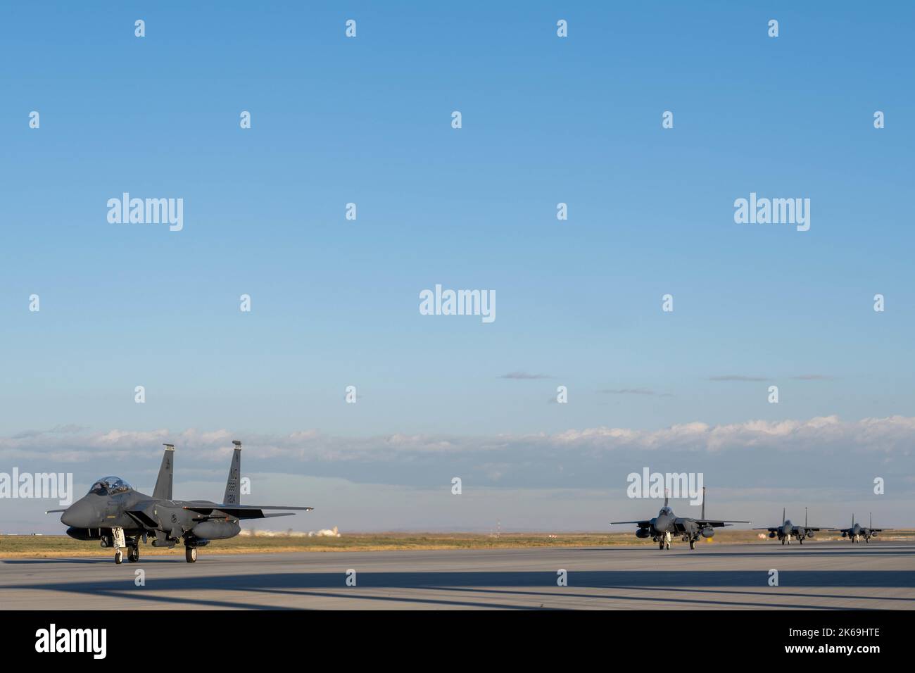 U.S. Air Force Airmen assigned to the 389th Fighter Squadron taxi F-15E ...