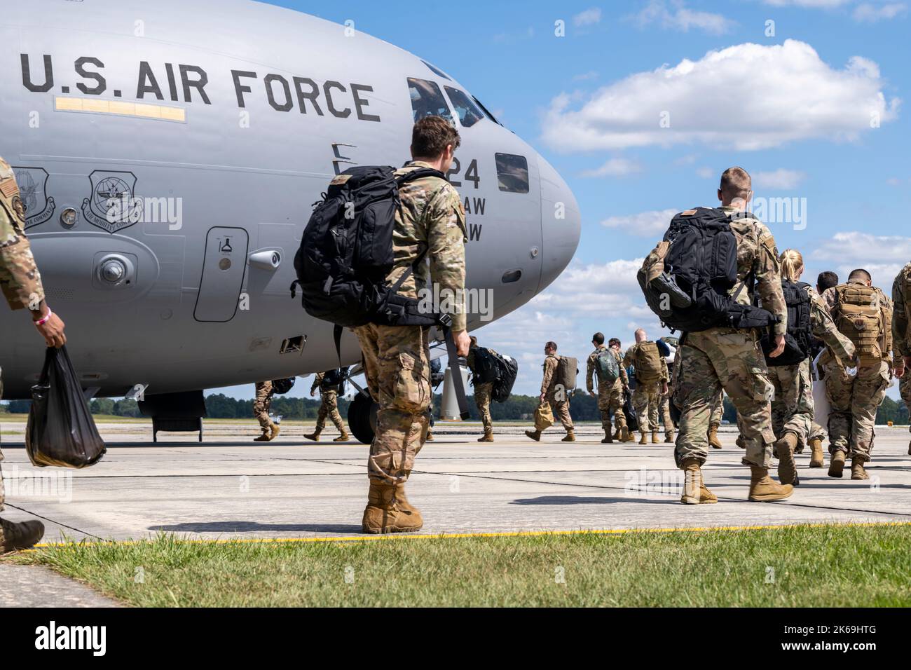 U.S. Air Force Airmen assigned to the 23rd Wing load onto a C-17 ...