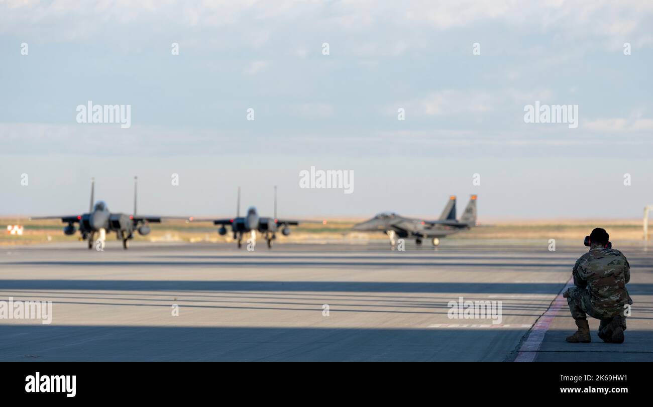 U.S. Air Force Airmen assigned to the 389th Fighter Squadron taxi F-15E ...