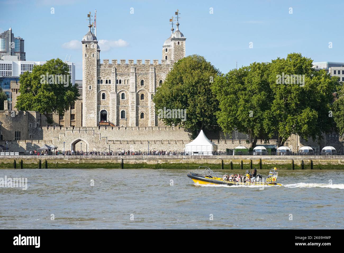 Tourist speedboat passing the Tower of London on the River Thames ...