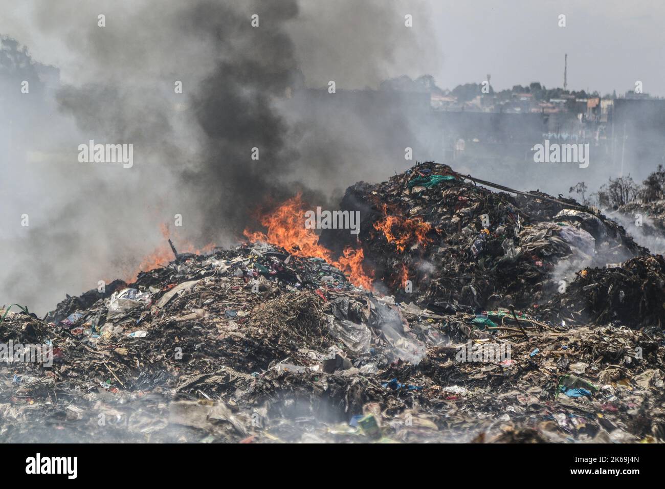 Smoke rises from burning rubbish at Dandora Dumping Site. There are ...