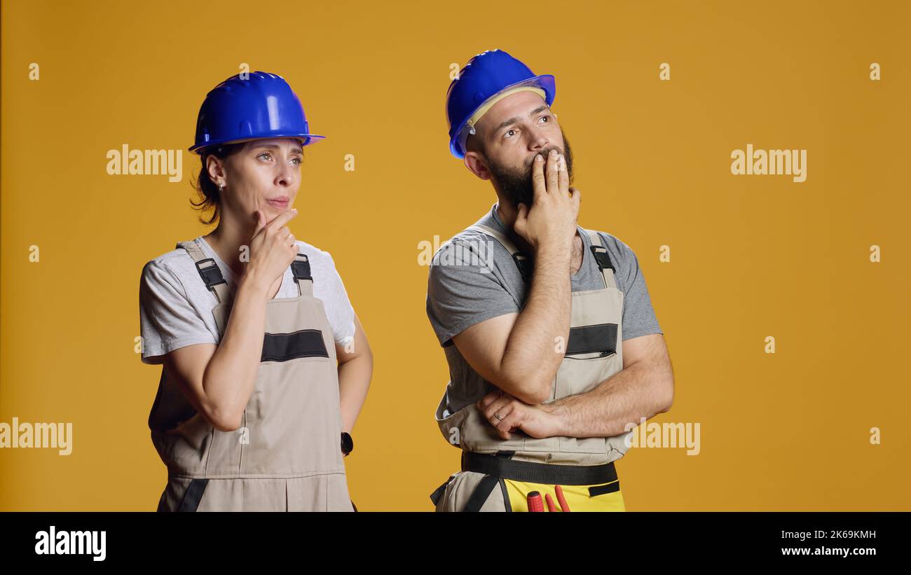 Team of builders brainstorming ideas to plan demolition, working on ...