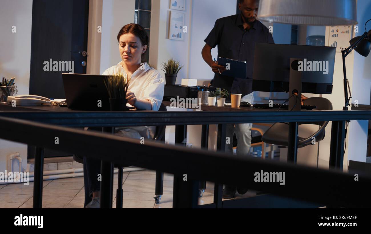 Disruptive female CEO working on laptop to plan report and send ...