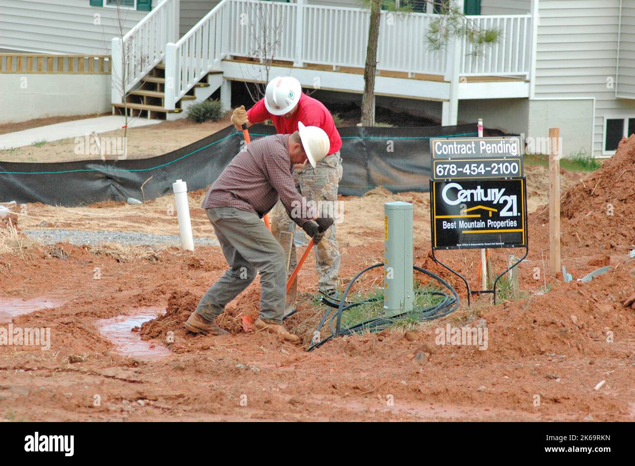 workman Installing telephone and power cable to new home house ...
