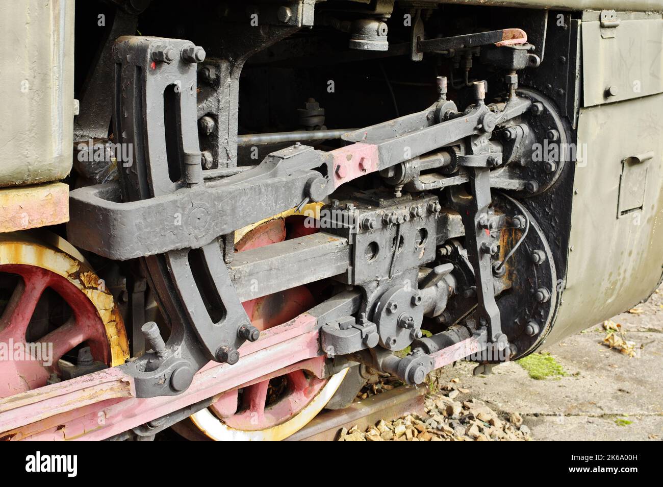 Old steam locomotive. A part of the suspension. Wheels and pistons are ...