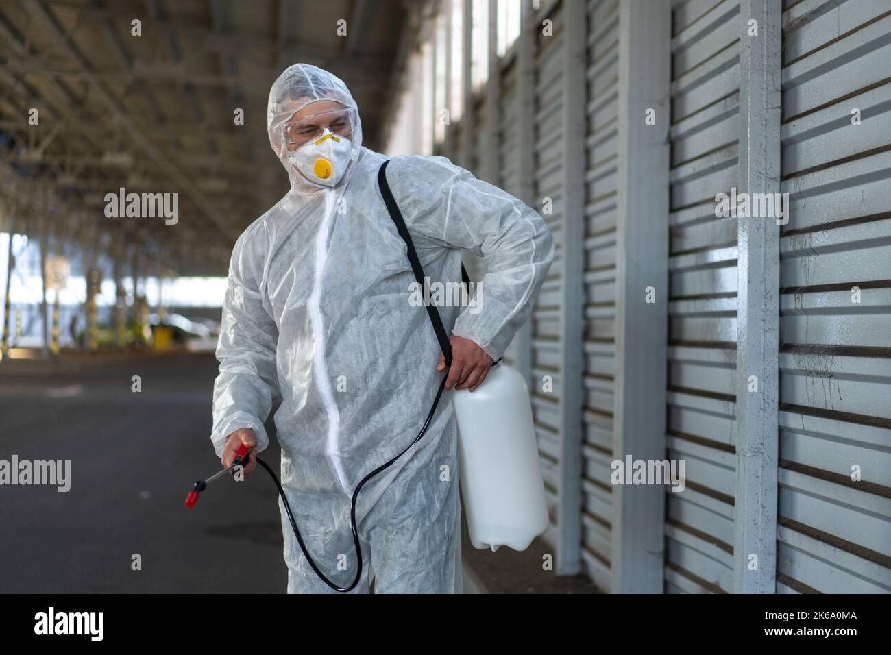 Worker wearing protective suit disinfection gear disinfect surface ...