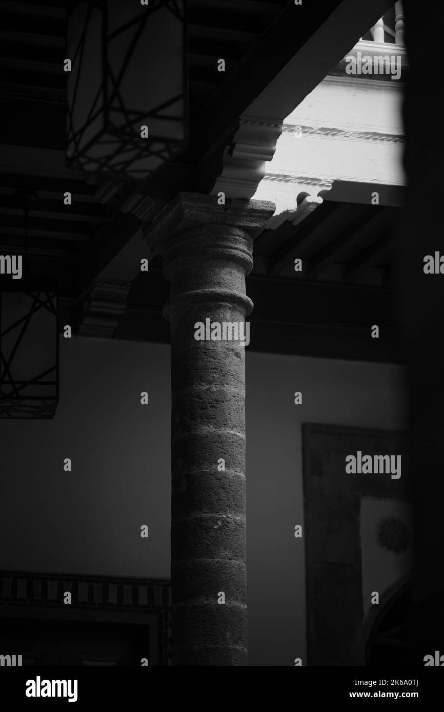 A vertical black and white pillar structure of the building Stock Photo ...