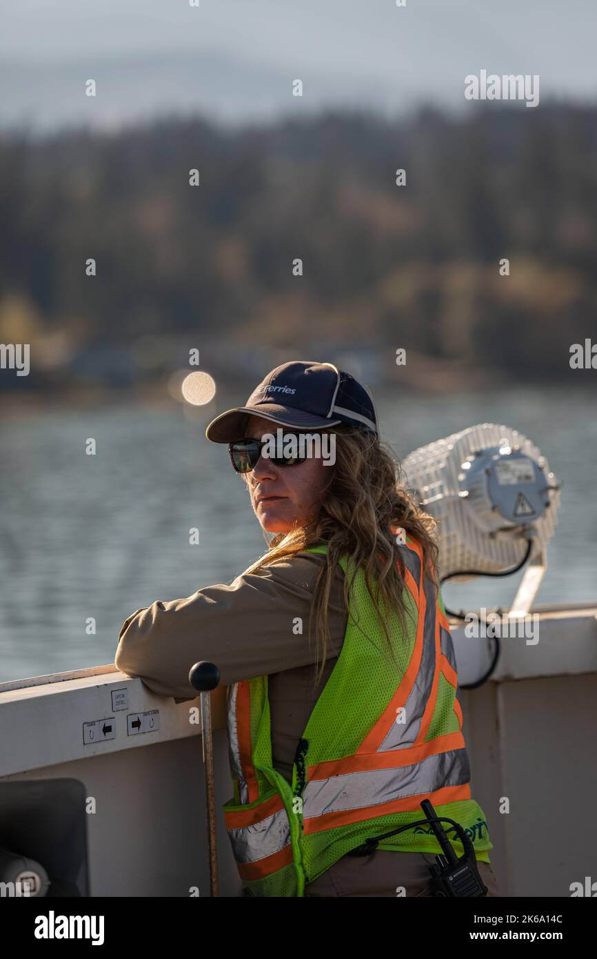 Female security officer in a safety vest standing at the BC Ferries ...