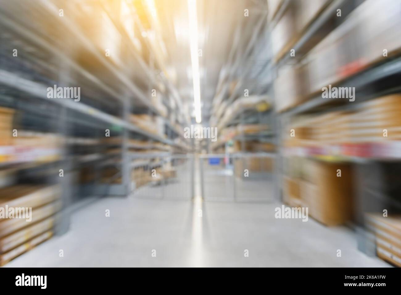 Blurred wholesale store with big boxes of product from floor to ceiling ...