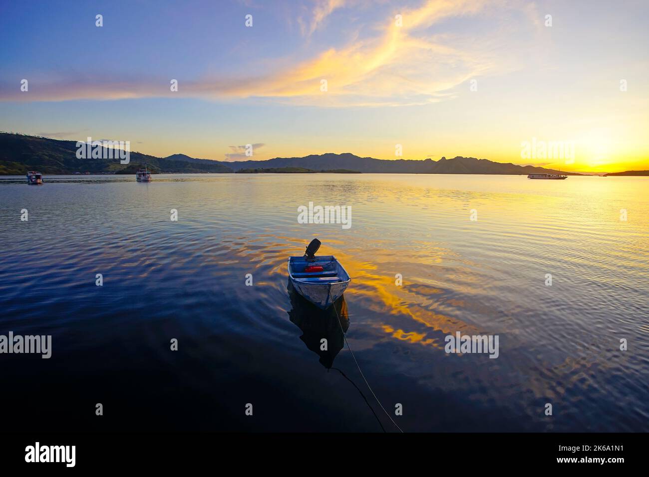 Lonely little boat with beautiful sunrise and reflection in water Stock ...