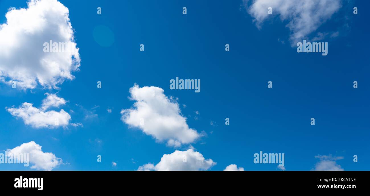 Bright luminous blue sky with scattered small white clouds Stock Photo ...