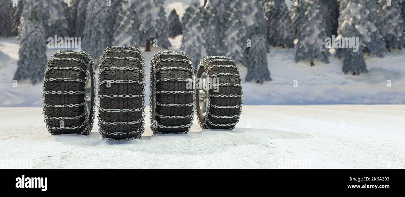 Four winter tires with snow chains on snow as panorama safety ...
