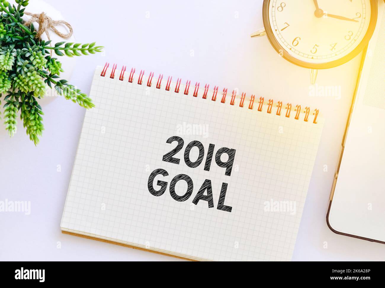 2019 Goal word on blank notepad with black alarm clock and laptop ...
