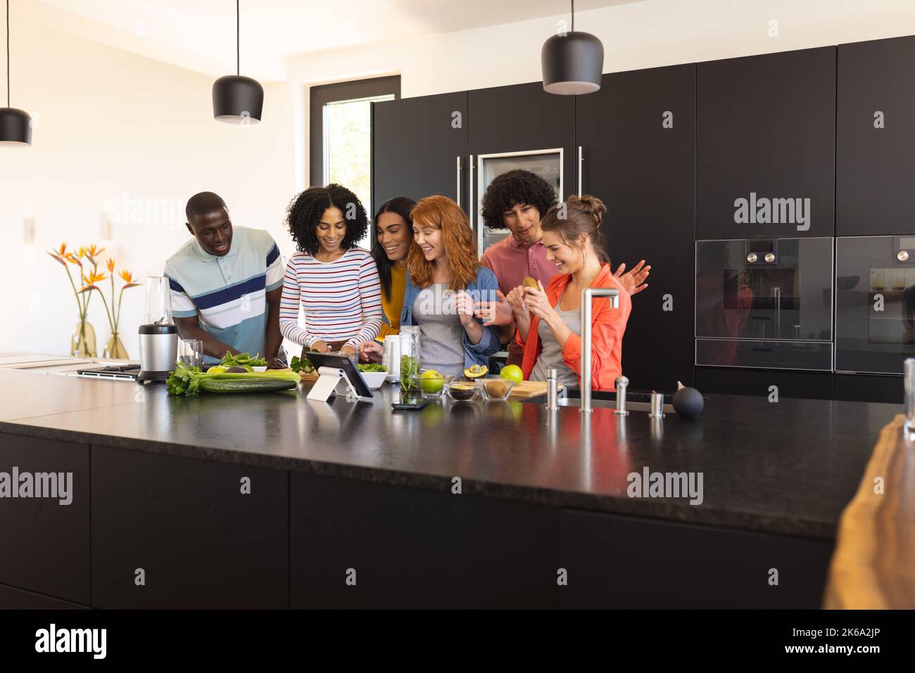 Happy diverse friends cooking together and smiling in kitchen Stock ...