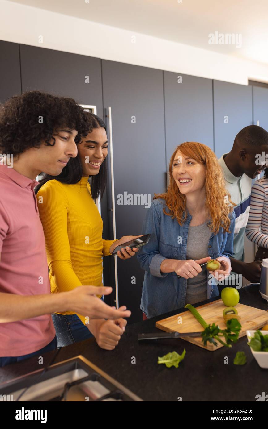 Happy diverse friends cooking together and smiling in kitchen Stock ...
