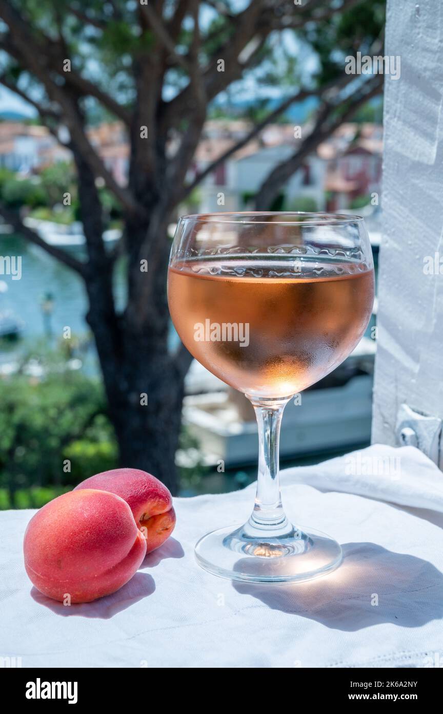 Drinking of cold rose wine from Provence with red apricots and view on ...