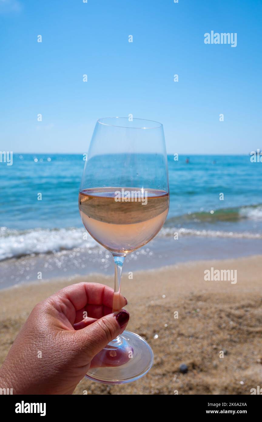 Cold rose wine from Provence served outdoor on white sandy beach Plage ...