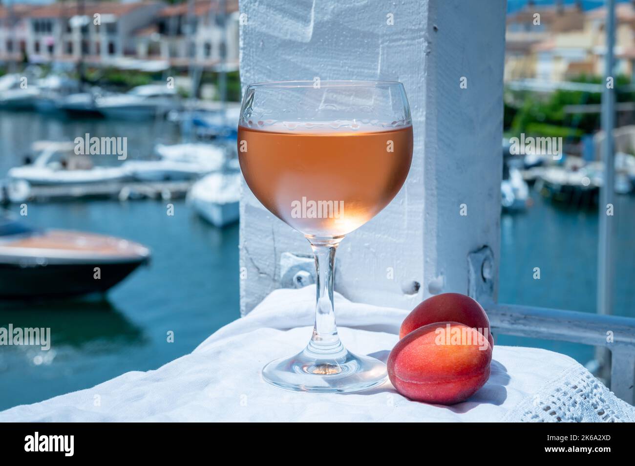 Drinking of cold rose wine from Provence with red apricots and view on ...