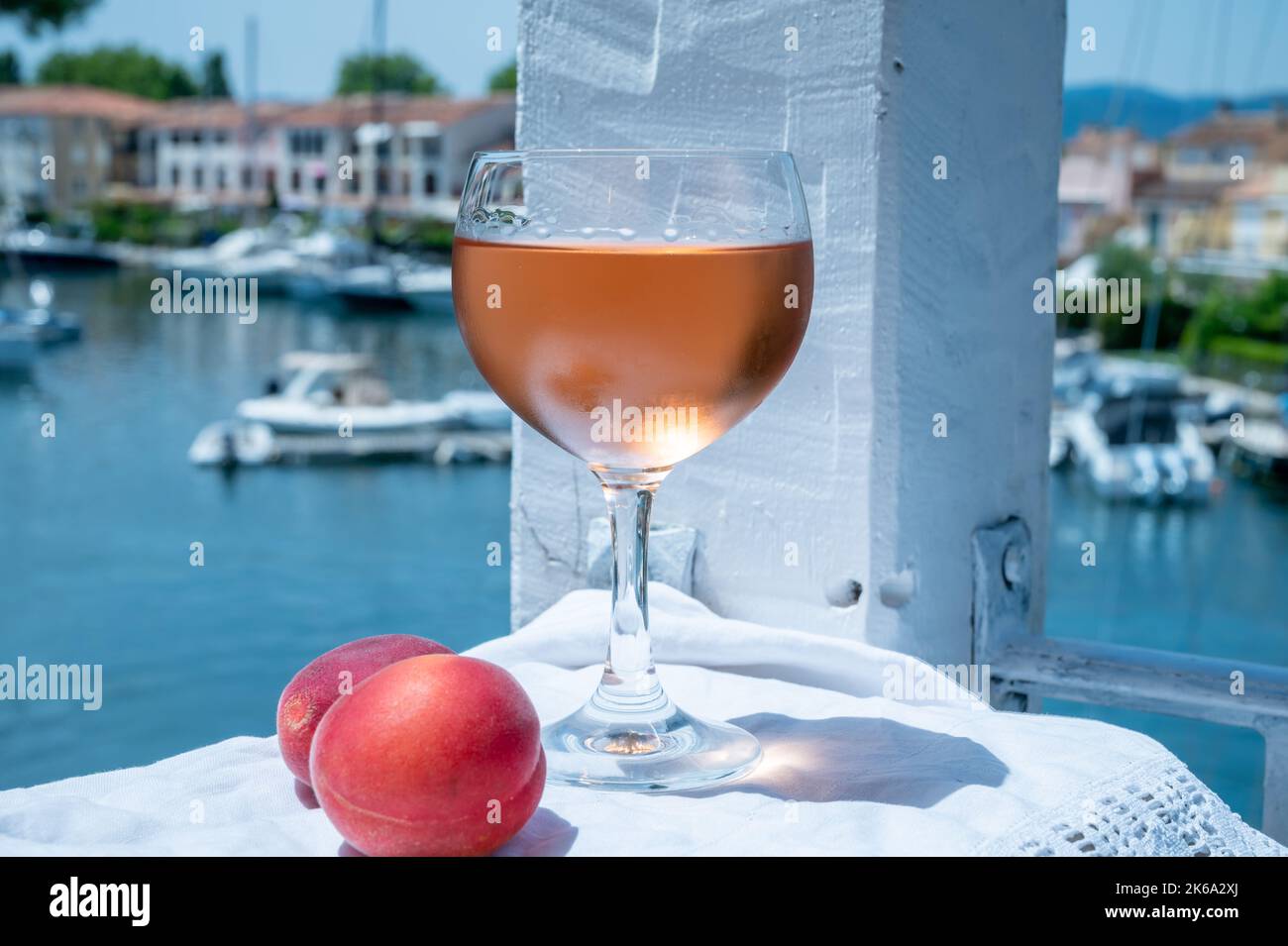 Drinking of cold rose wine from Provence with red apricots and view on ...