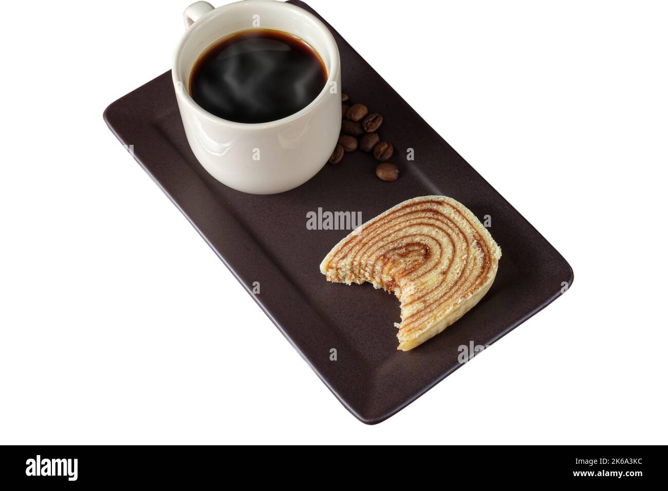 Bolo de rolo slice with a bite next to a cup and coffee beans (white ...