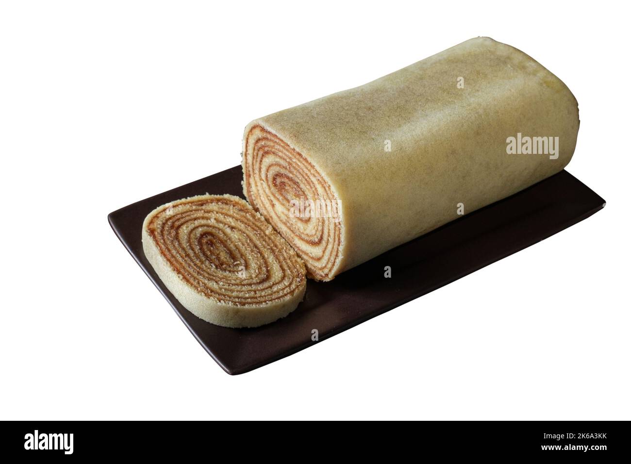 Bolo de rolo slice on a brown plate side view (white background Stock ...