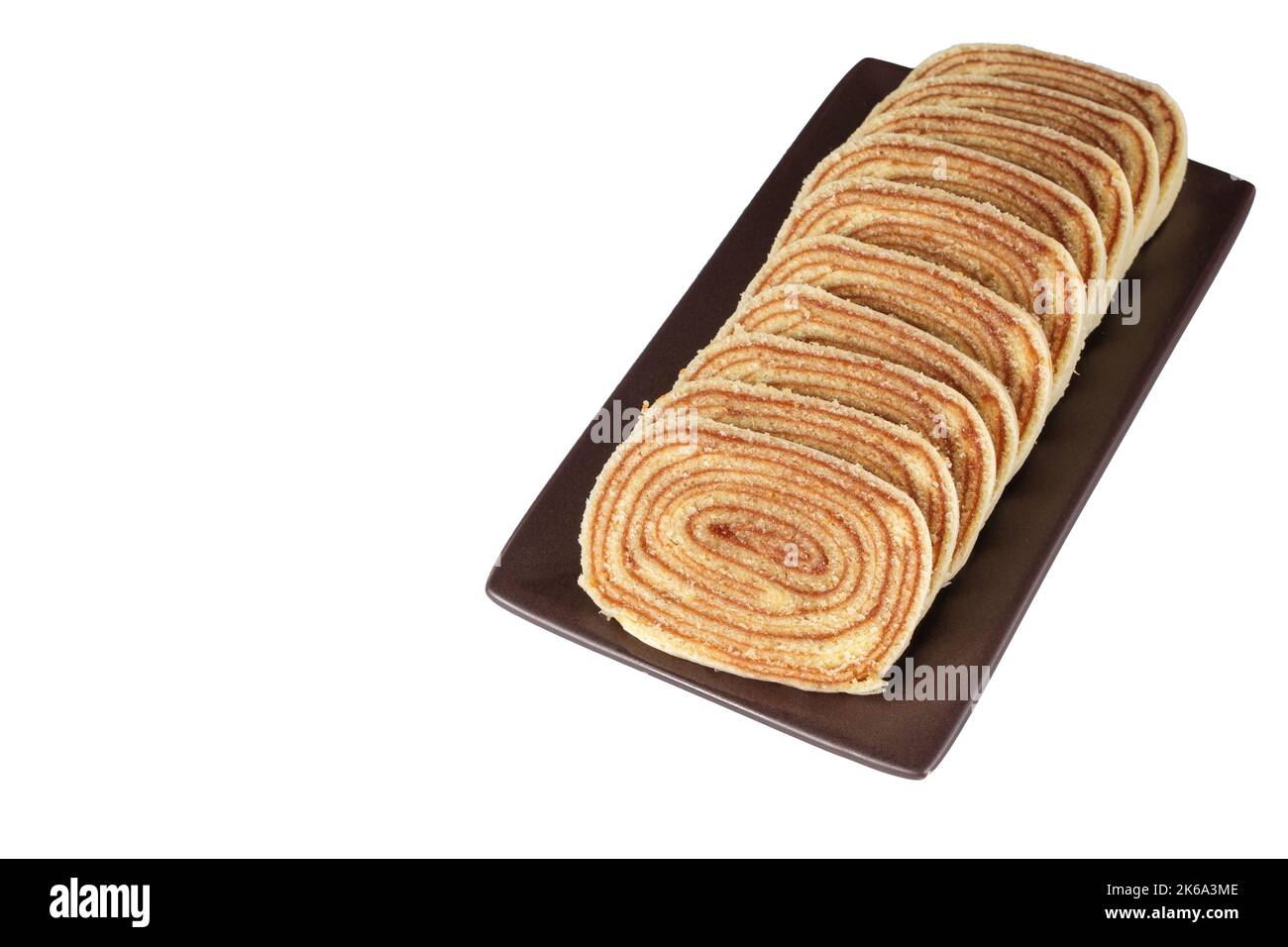 Sliced bolo de rolo on a brown plate (white background Stock Photo - Alamy