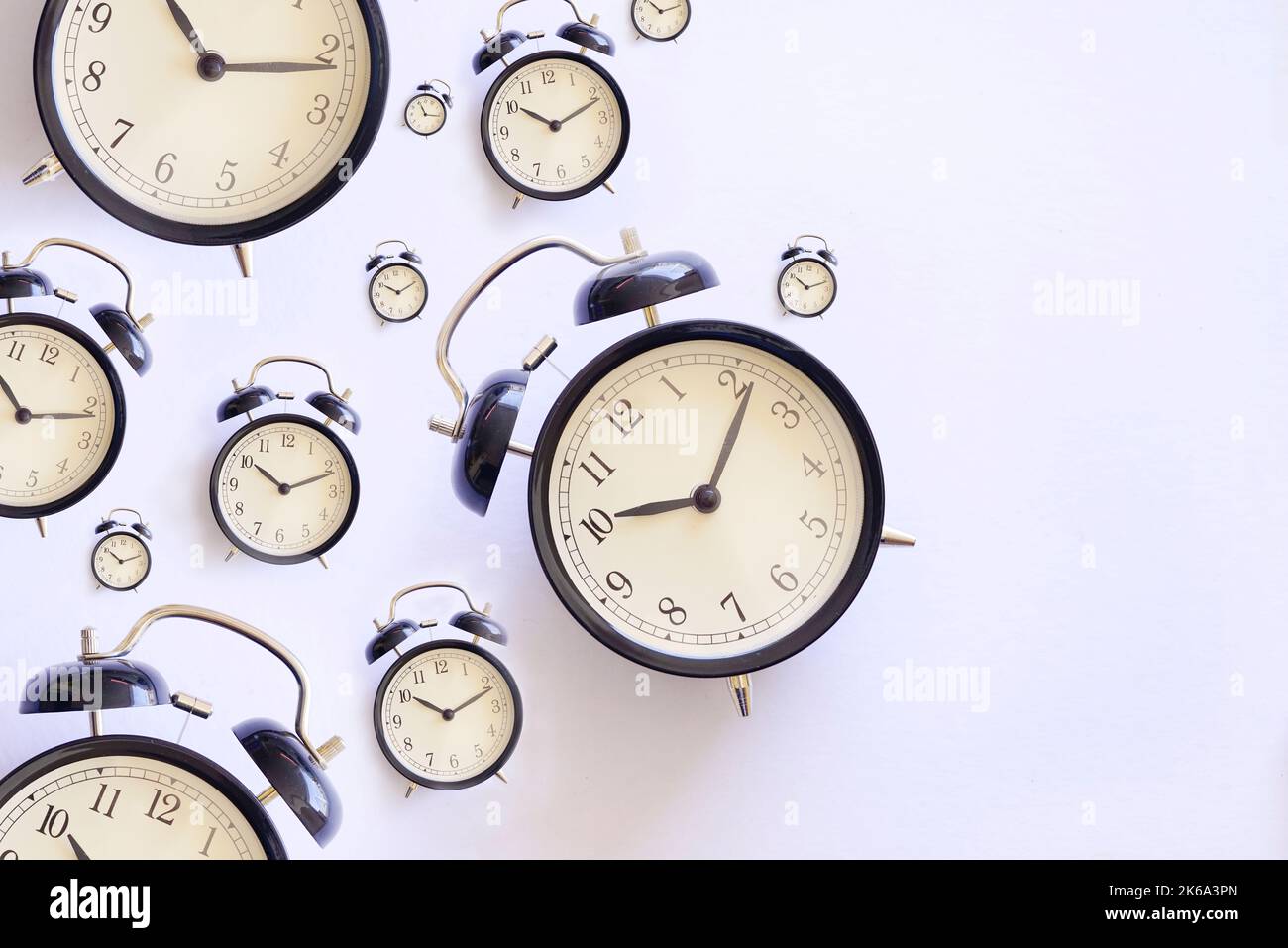 Many black alarm clock on white background. Flatlay topview Stock Photo ...