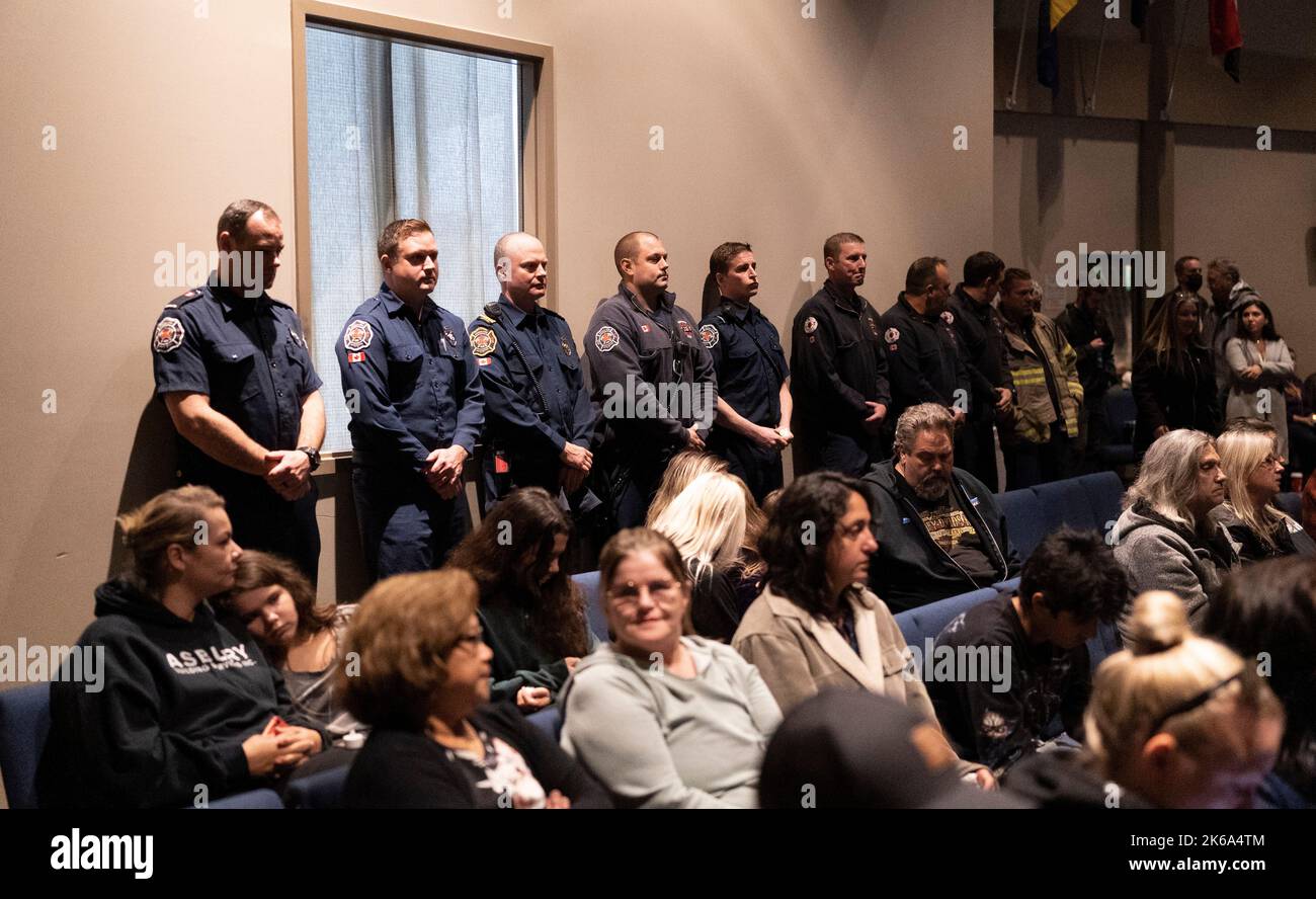 Firefighters and members of the Innisfil community attend a candlelight ...