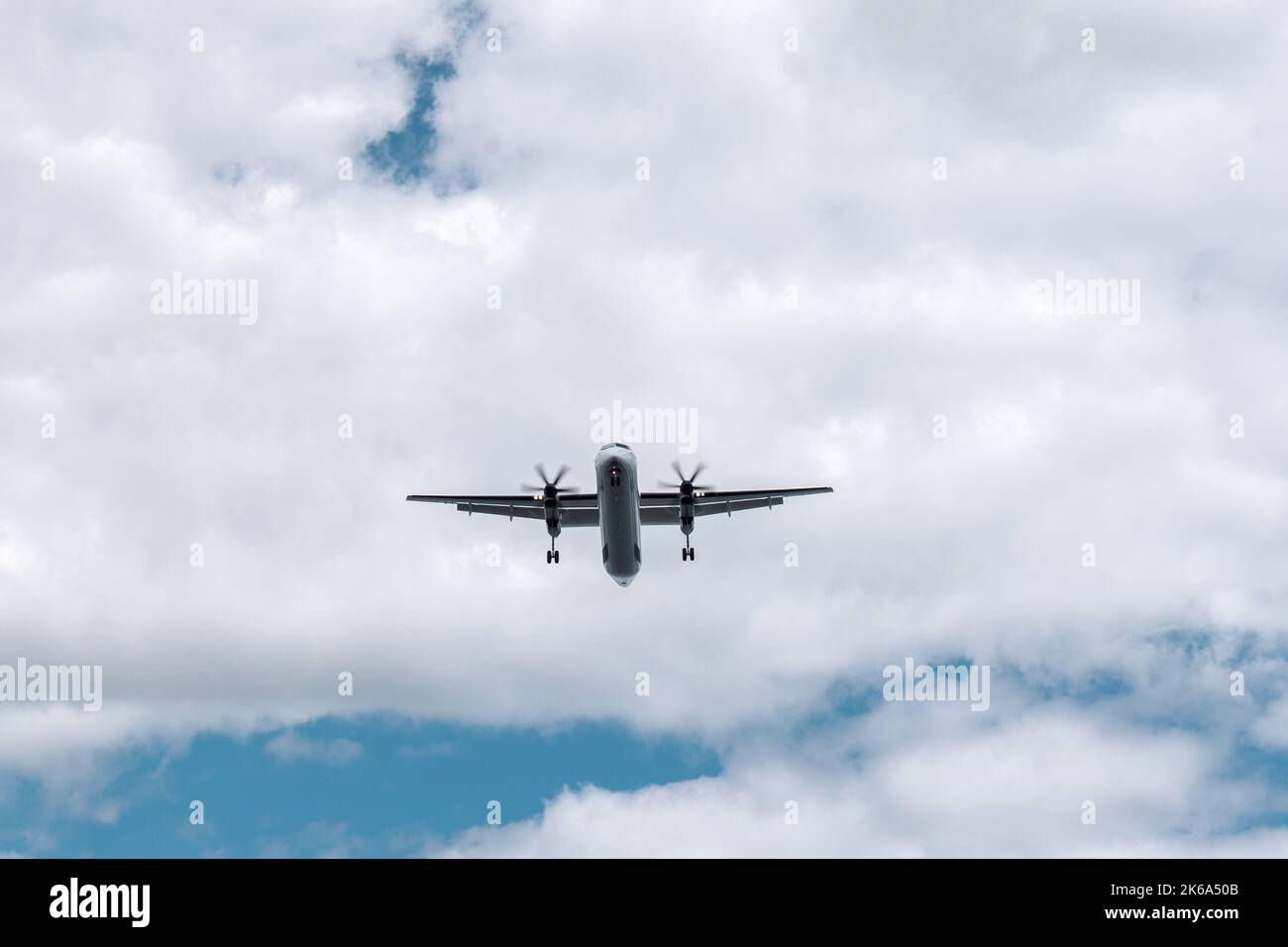 Small propeller plane flying above the head before landing. Bottom of ...