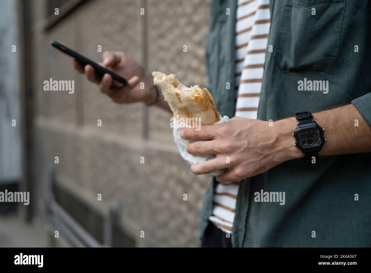 Man eating sandwich standing hi-res stock photography and images - Alamy