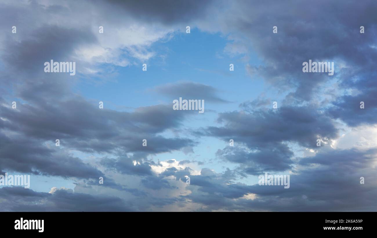 Dark cloud moving in under blue skies Stock Photo - Alamy