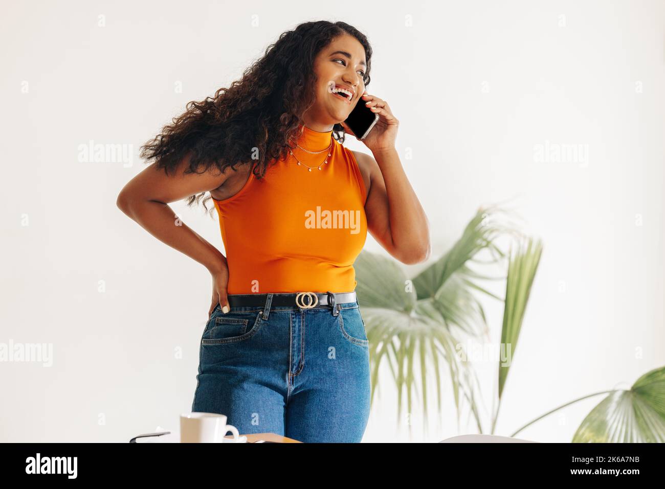 Young businesswoman smiling happily while speaking with her business ...