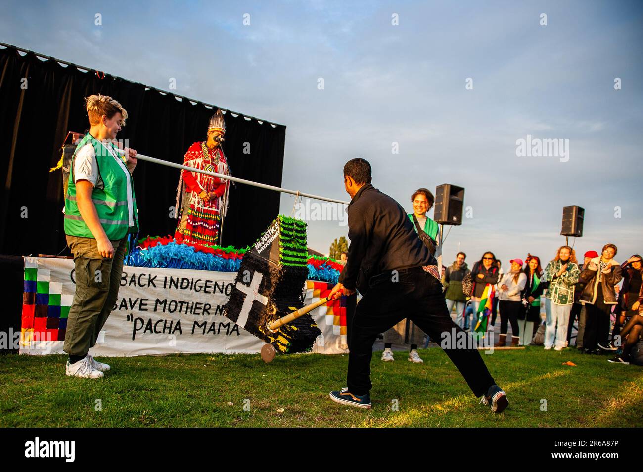 A man is seen destroying a piñata in the shape of a Catholic church ...