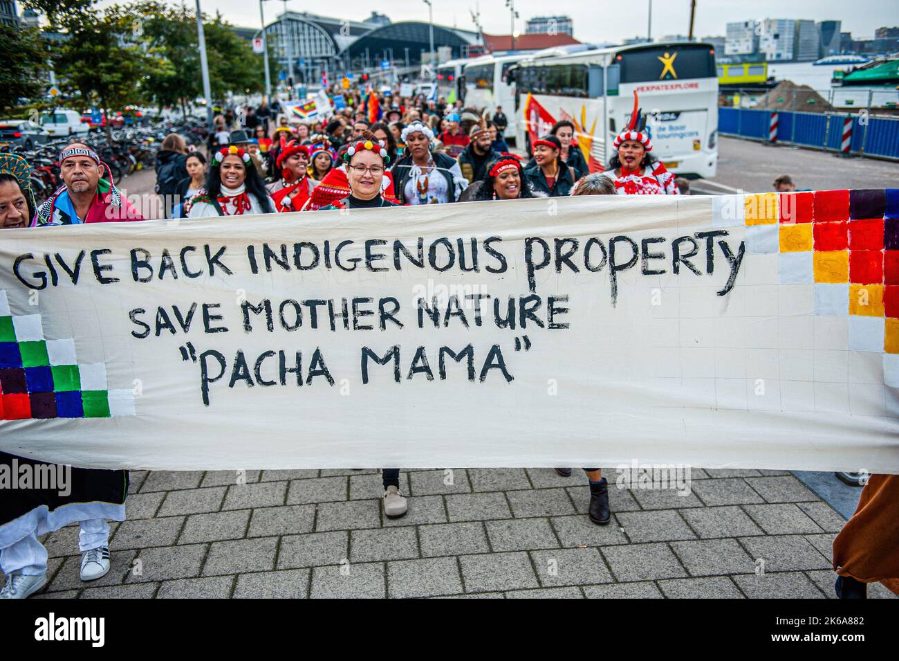Indigenous people are seen walking behind a banner asking for their ...