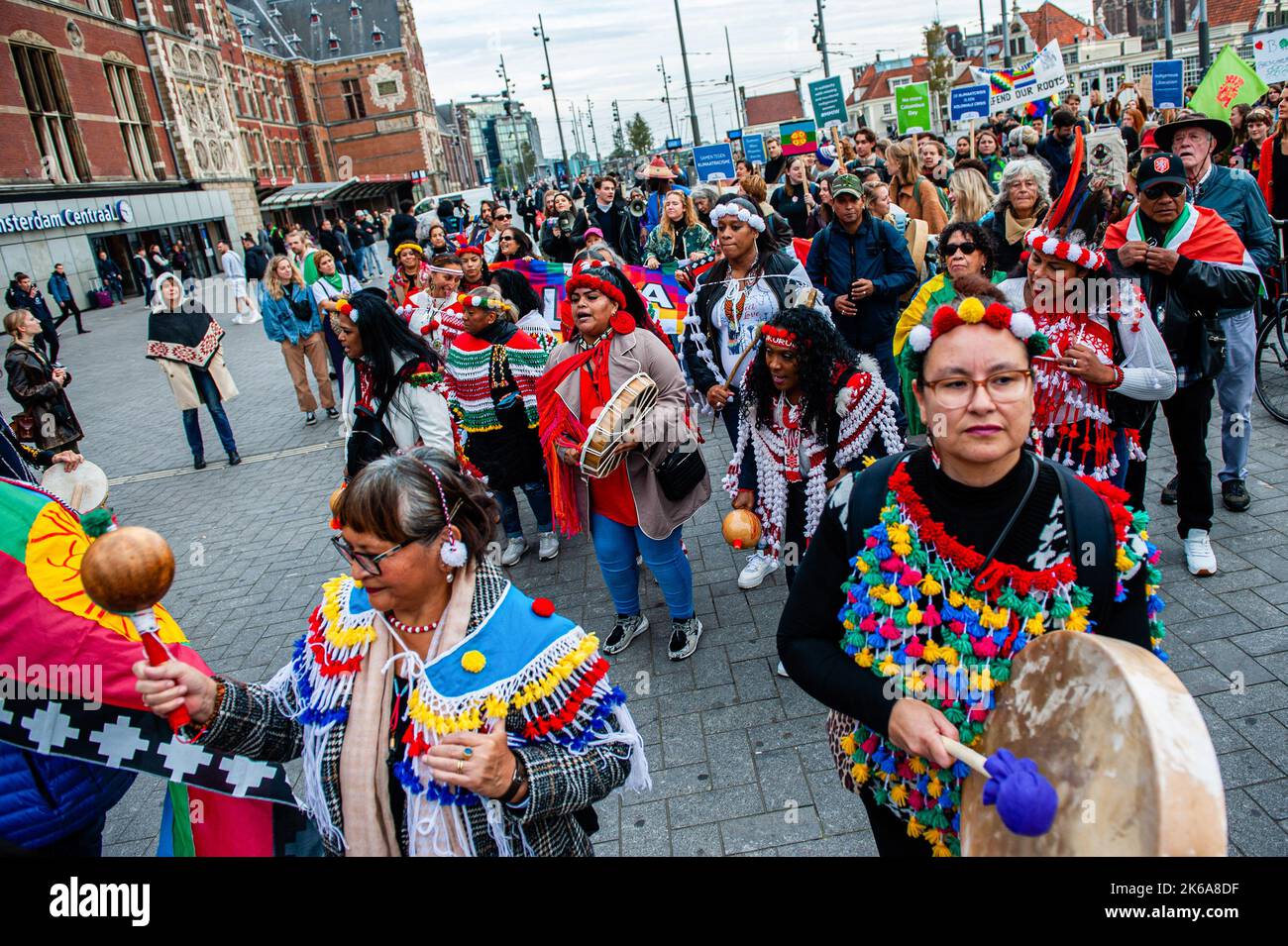 Indigenous women are seen playing traditional instruments during the ...