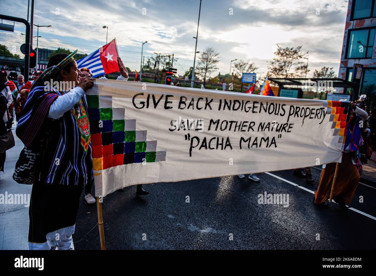 Protesters are seen holding a big banner demanding Indigenous rights ...